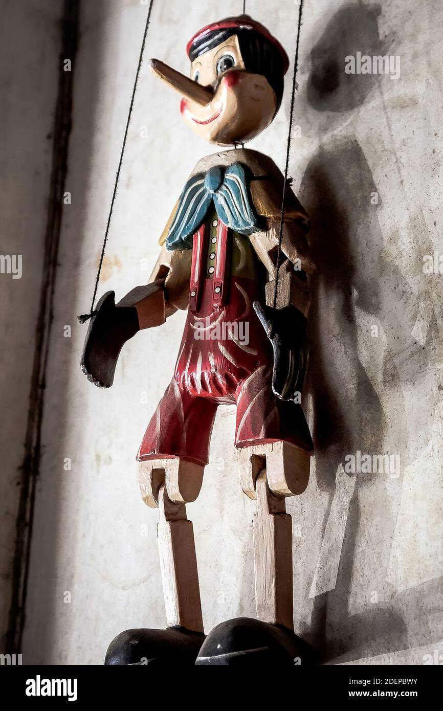 A vertical shot of a wooden Pinocchio puppet Stock Photo - Alamy