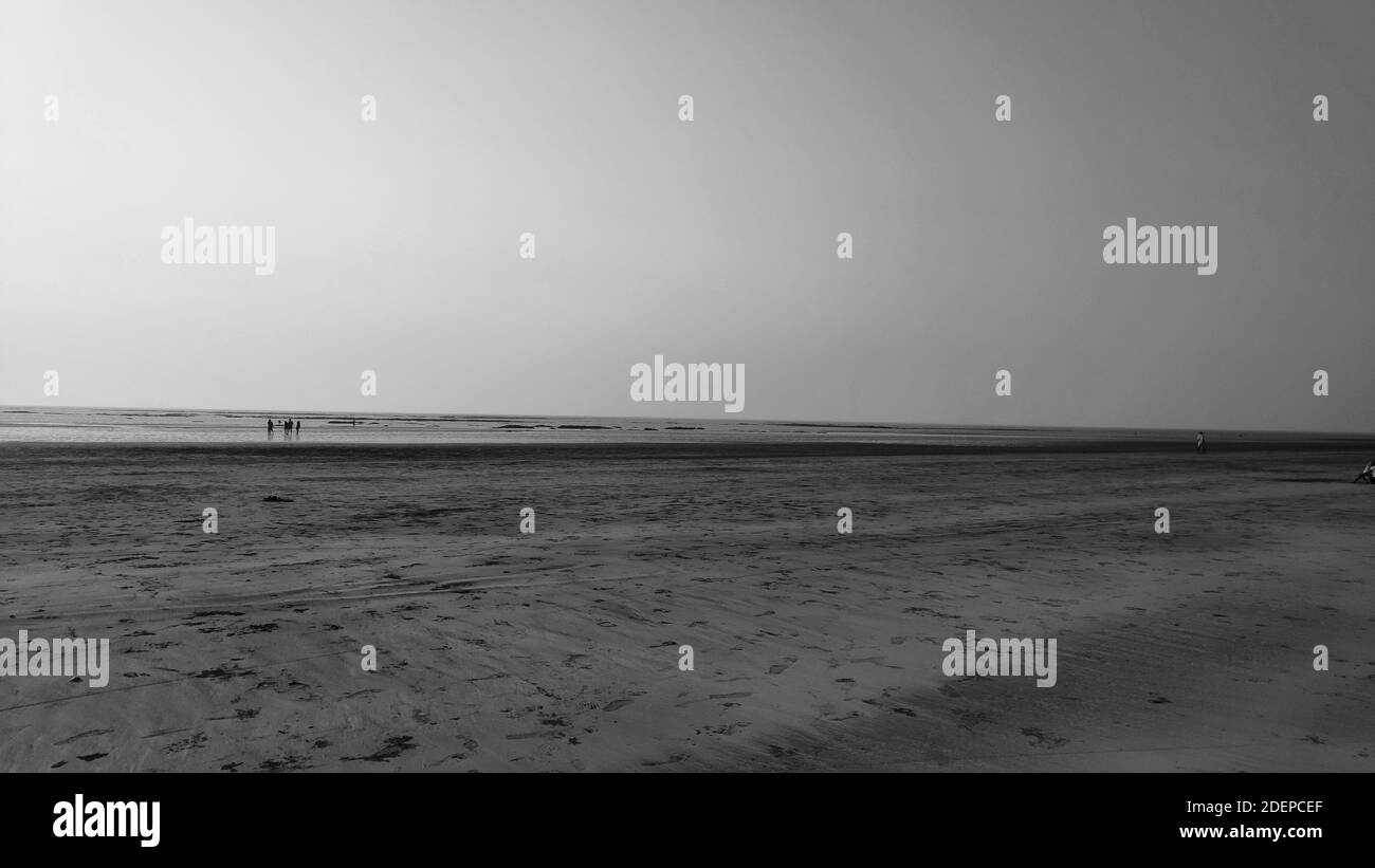 A grayscale of a sandy beach on background of a boundless sea Stock ...
