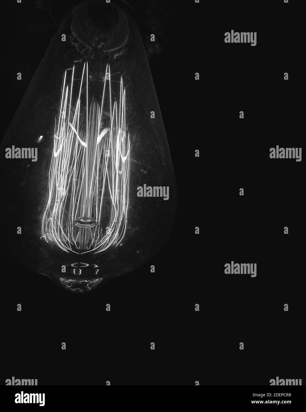 A vertical grayscale of an abstract Edison light bulb Stock Photo - Alamy