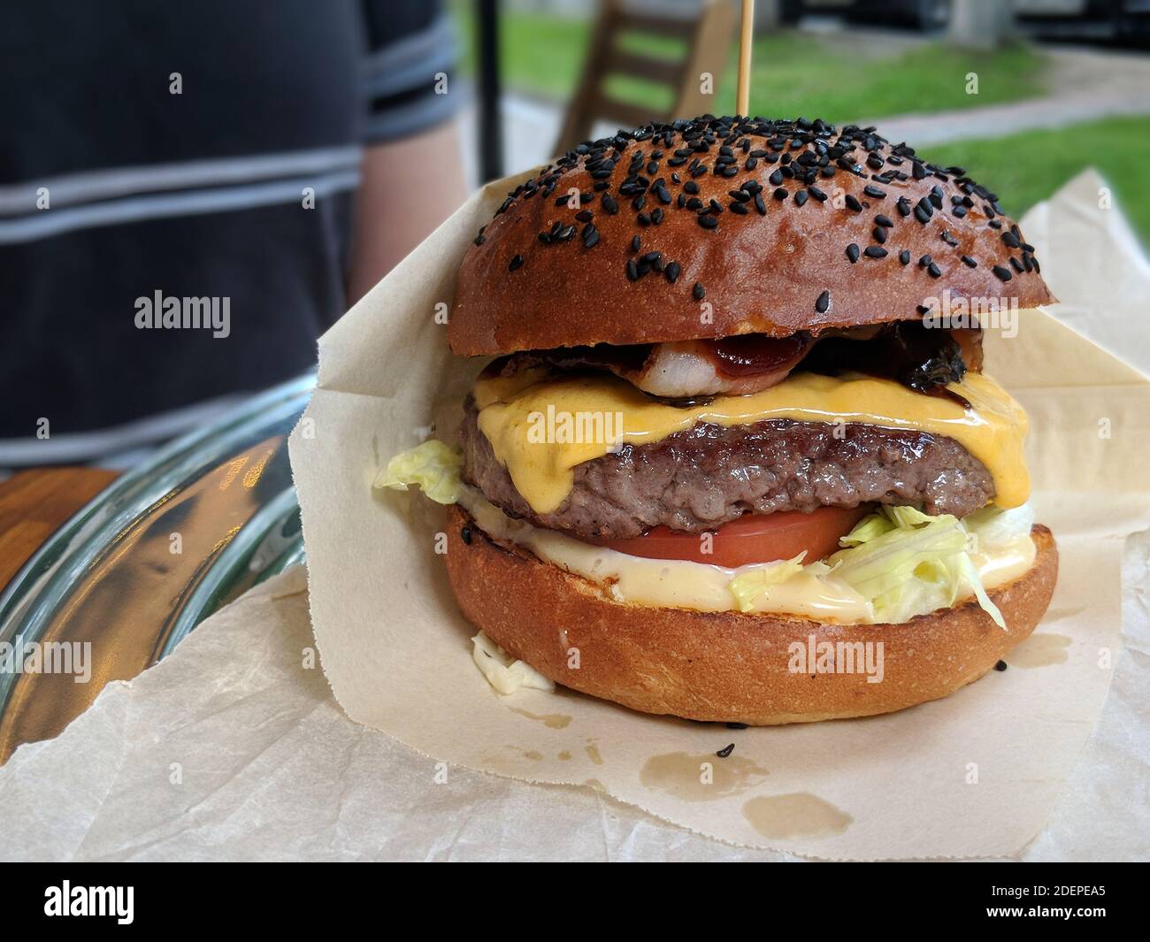 Delicious juicy bacon cheeseburger in an outdoor restaurant. Gourmet ...