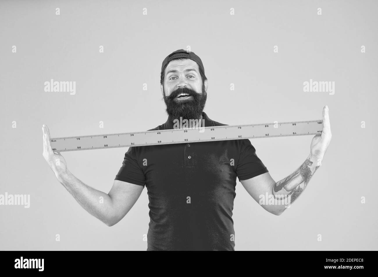 Hipster man in cap with big measuring instrument. Size of parcel. Post ...