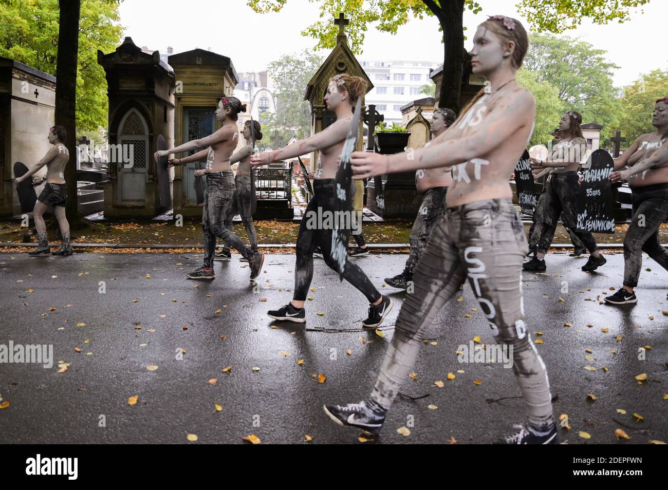 Women hold signs with the name of victims of femicide as they take part ...