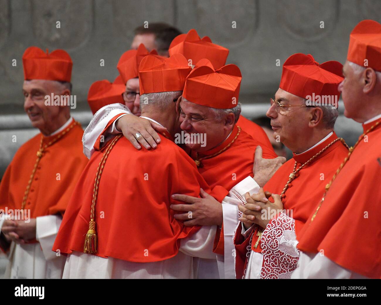 Polish cardinal Konrad Krajewski greets a new cardinal during a ...