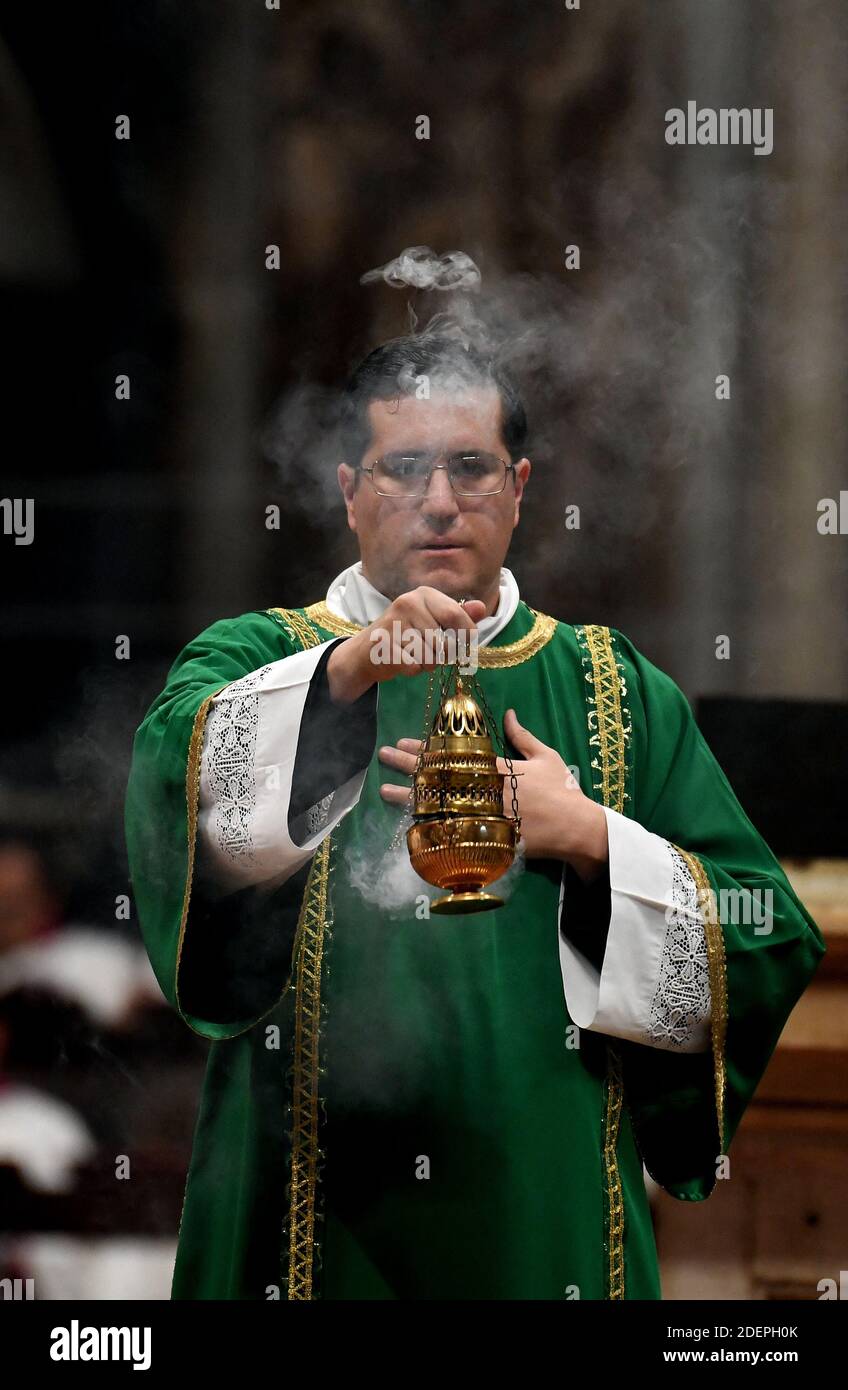 A priest holds a thurible (encensoir) as pope Francis celebrates a mass ...
