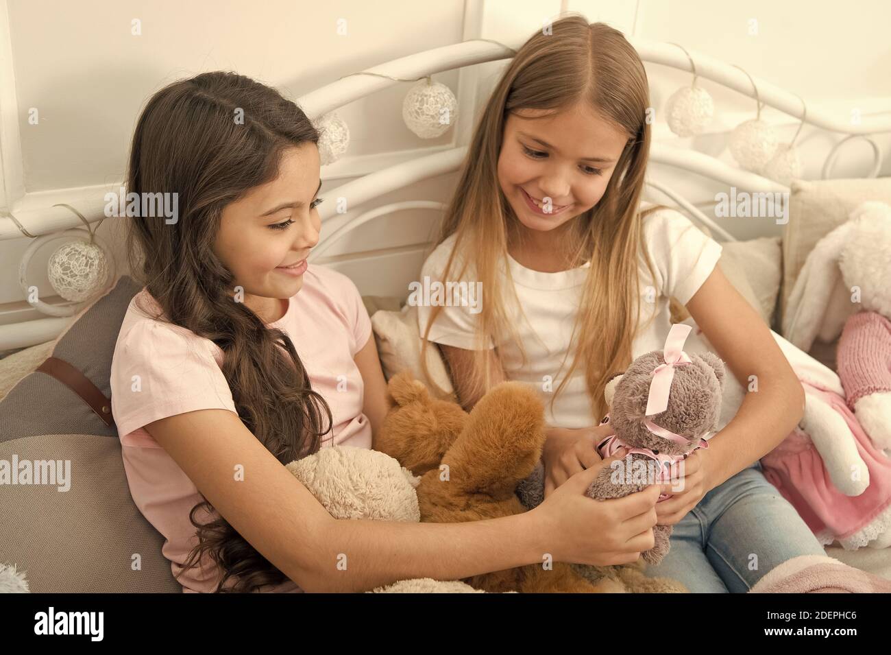 True friendship. Small friends play toys in childrens room. Enjoying ...