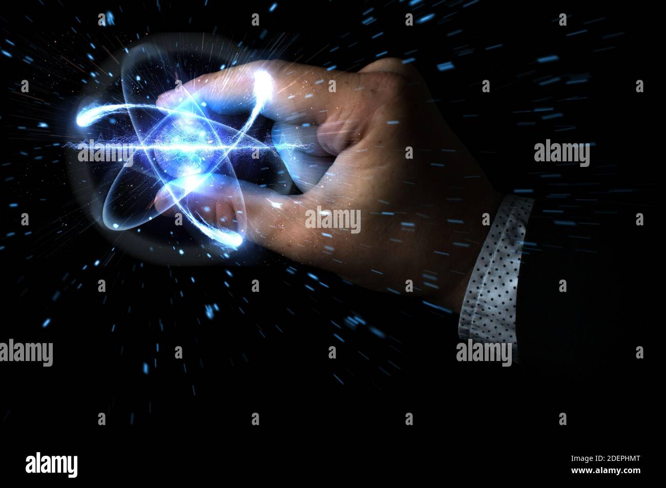 Scientist man holding atom particle between his fingers Stock Photo - Alamy