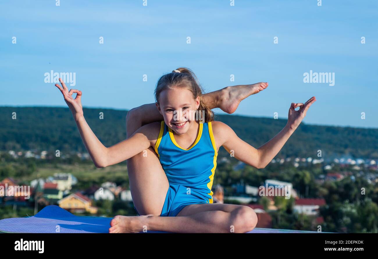 gymnastics and yoga meditation. happy teen girl on sky background. kid ...