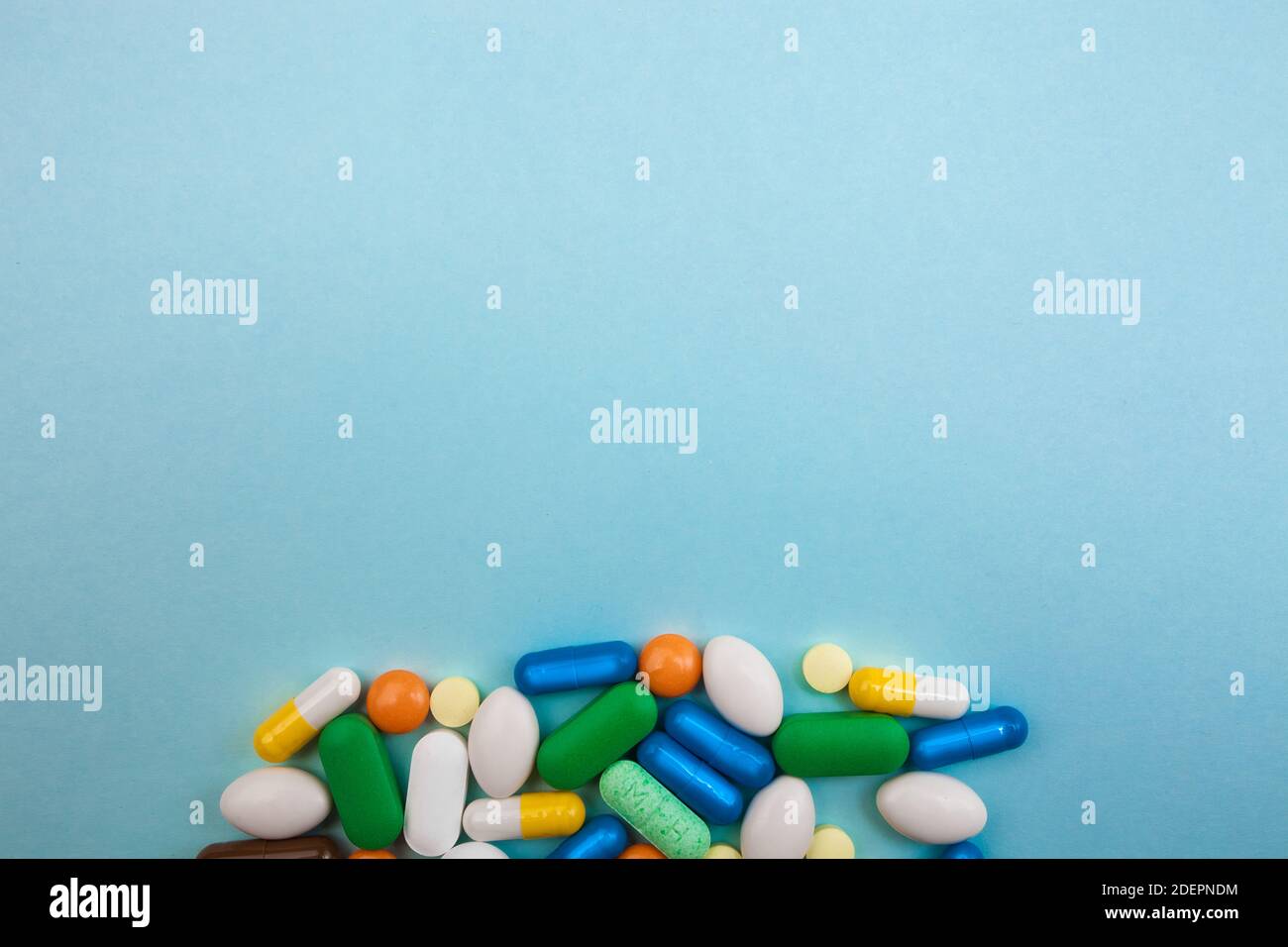 Multi-colored tablets and capsules, pharmaceutical medicine pills on ...