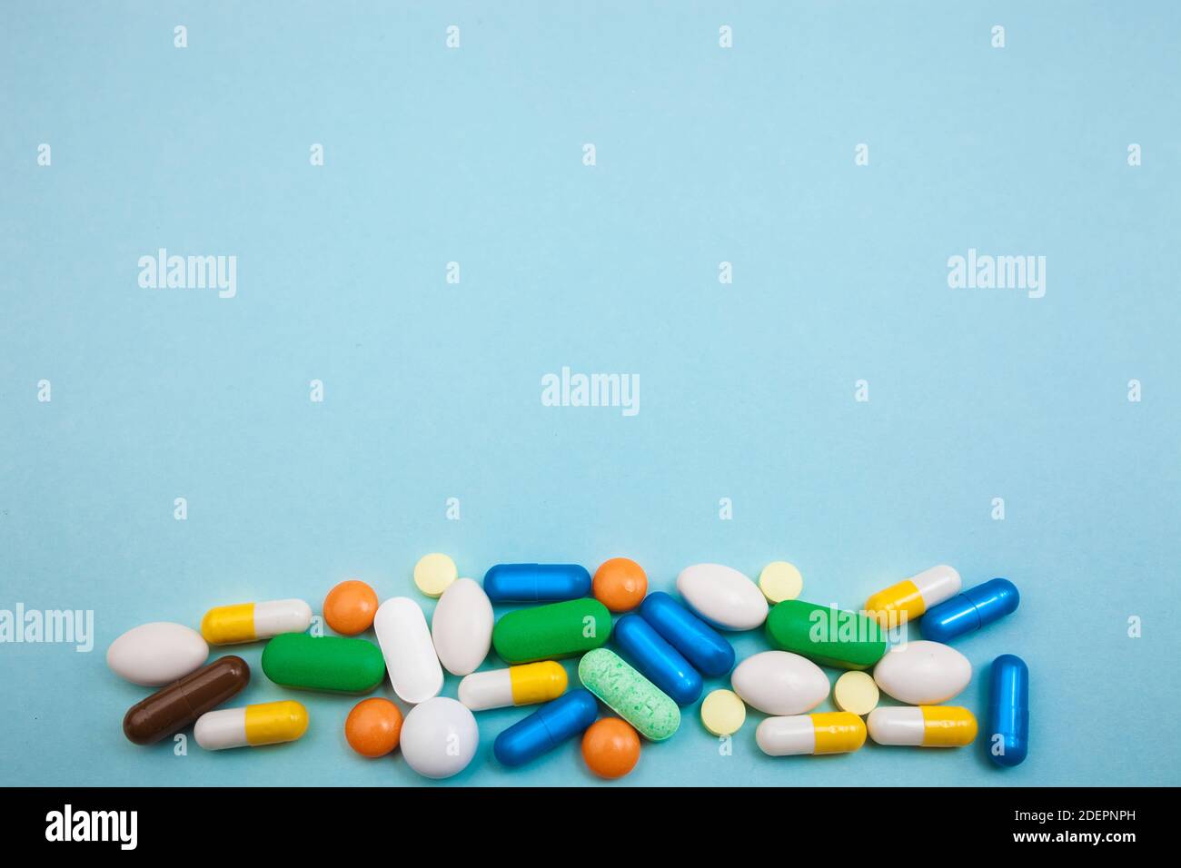 Multi-colored tablets and capsules, pharmaceutical medicine pills on ...