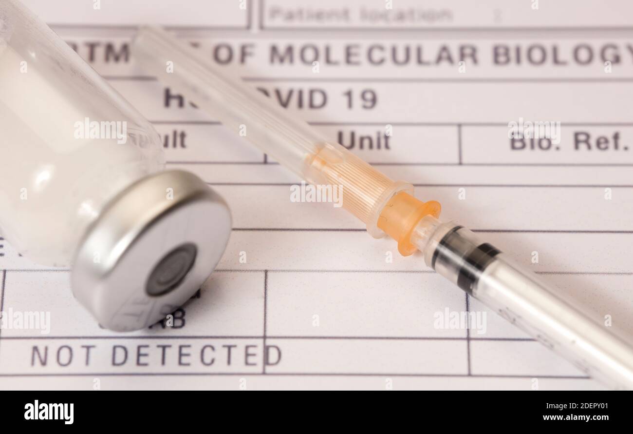 Vaccine vial, syringe, on top of pcr medical form for covid-19 Stock ...