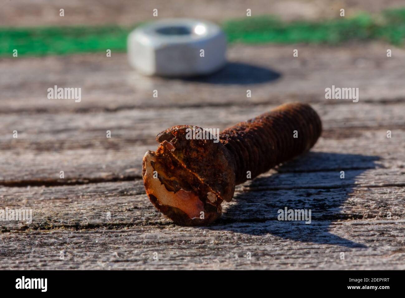 old rusty screw on a old wooden table Stock Photo - Alamy