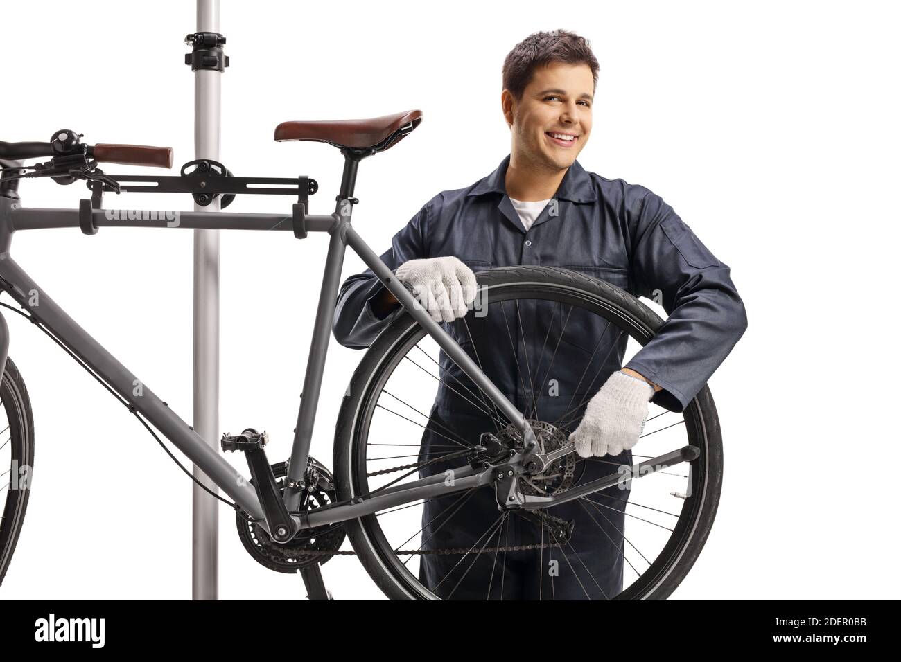 Bicycle mechanic fixing a bicycle wheel and smiling isolated on white ...