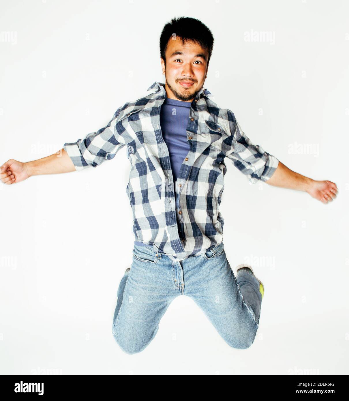 young pretty asian man jumping cheerful against white background ...