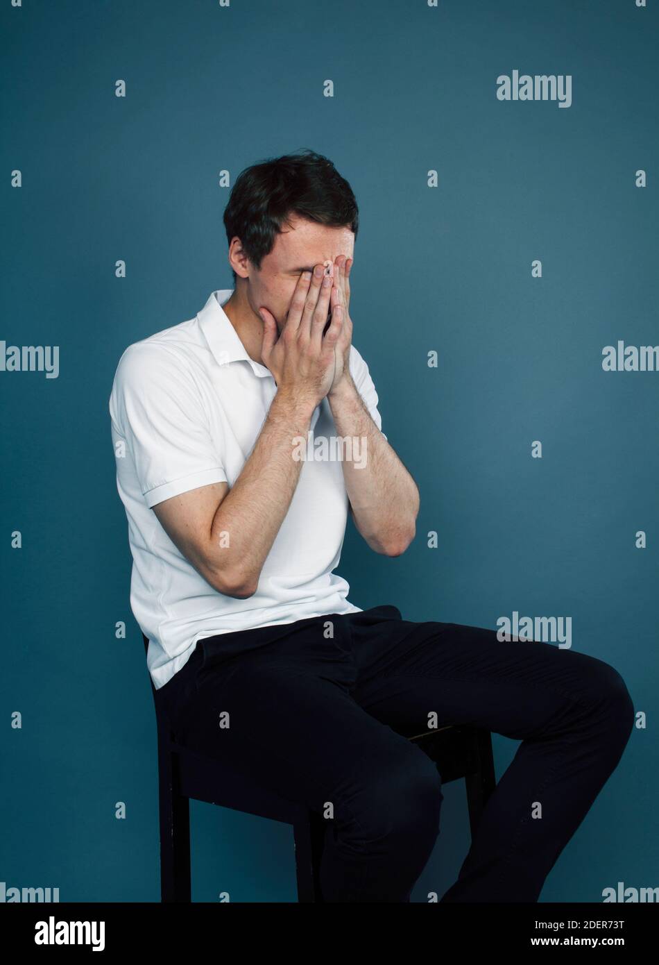 young goofy man with pimples pointing gesturing in studio, stupid ...