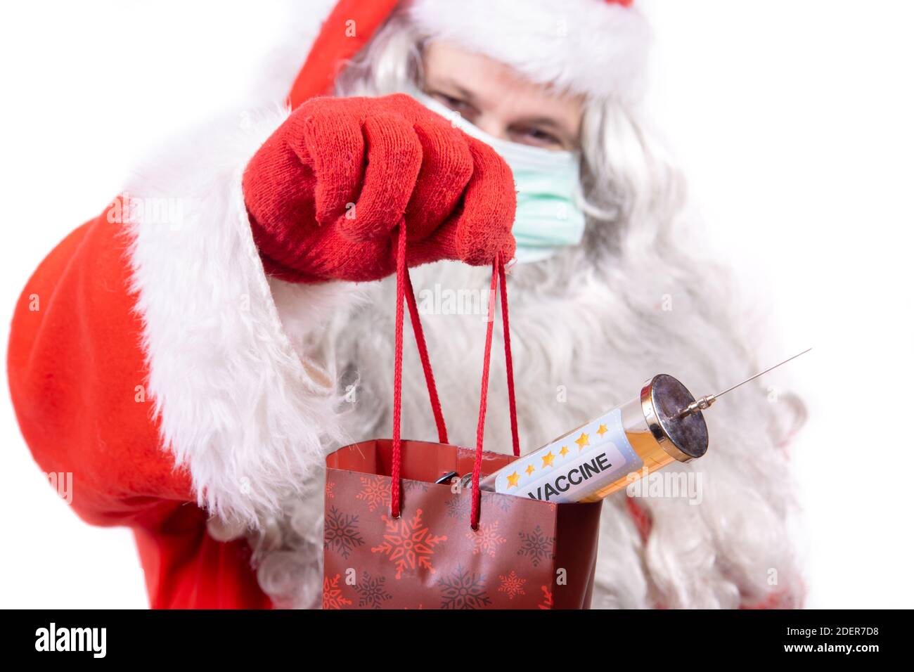 Santa Claus with face mask offers Christmas gift a vaccine injection ...