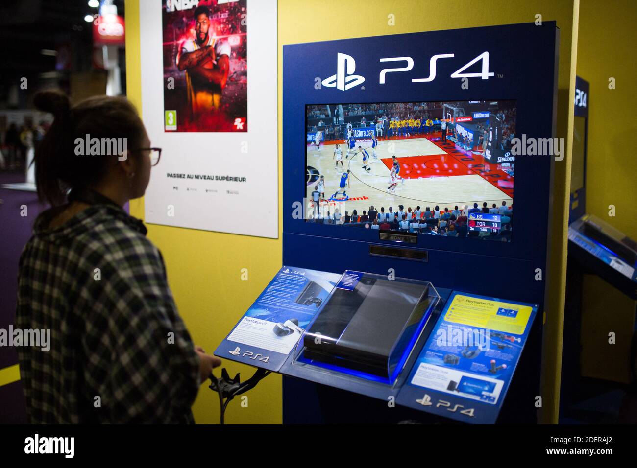 People playing video games on the Sony PS4 console at the Paris Games ...