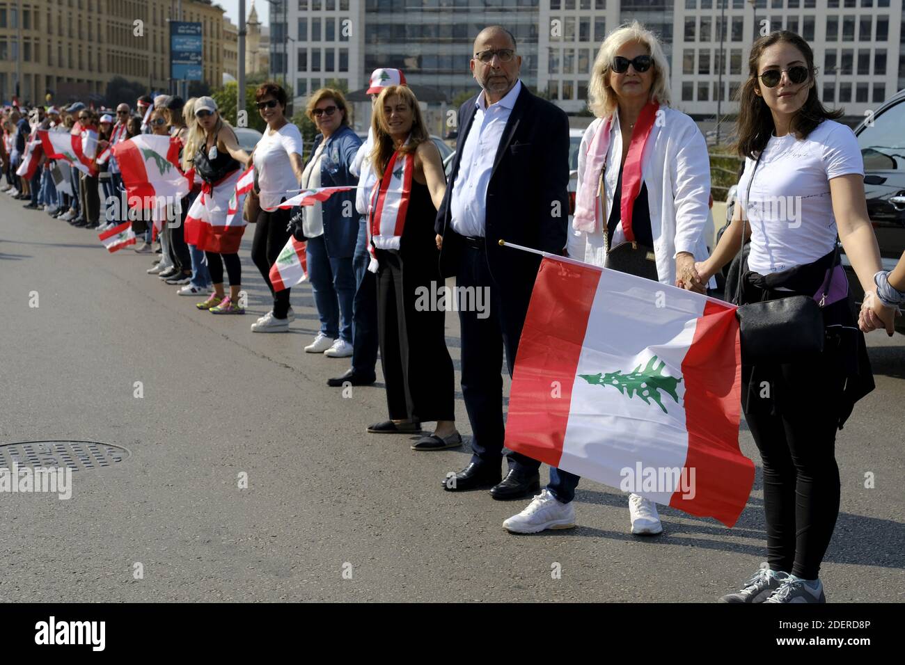 Lebanese people hold hands as they form a human chain, that stretched ...