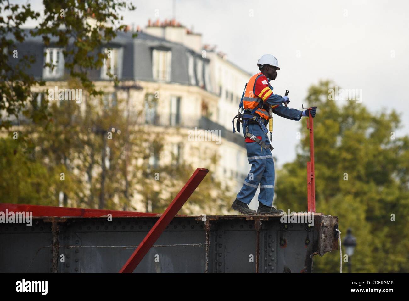 A worker walks on a beam during the visit of Paris mayor at a ...