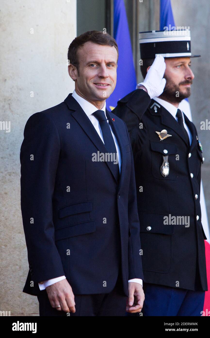 France's President Emmanuel Macron smiles as he waits for guests at the ...