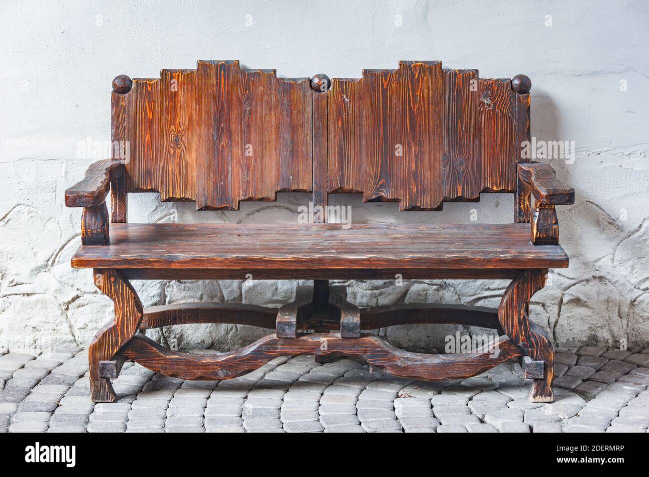 Wooden retro bench by the stone wall Stock Photo - Alamy