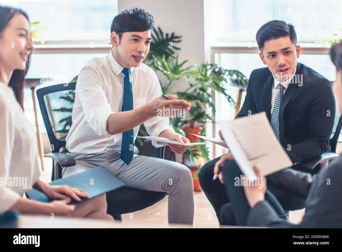 Corporate business team and manager discussing in office Stock Photo ...