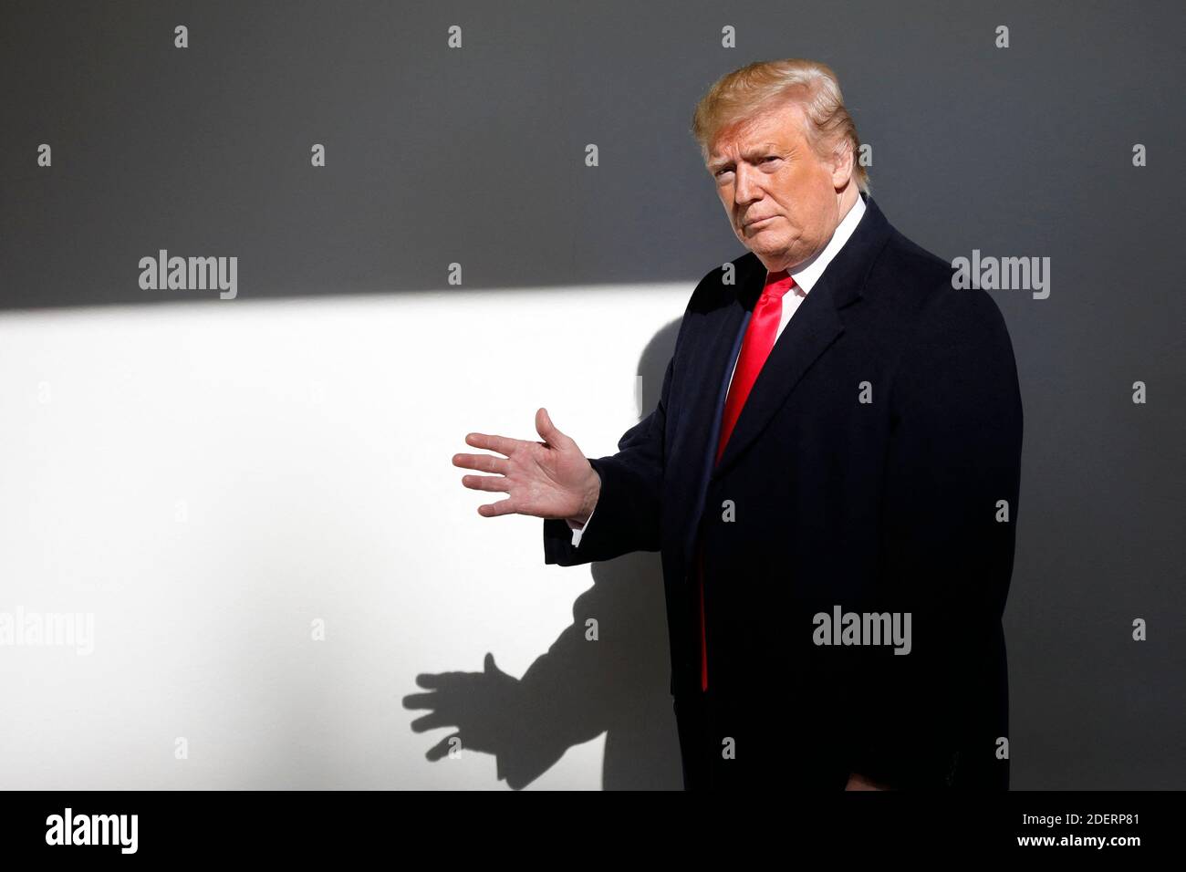 U.S. President Donald Trump waves as he walks to the Oval Office at the ...