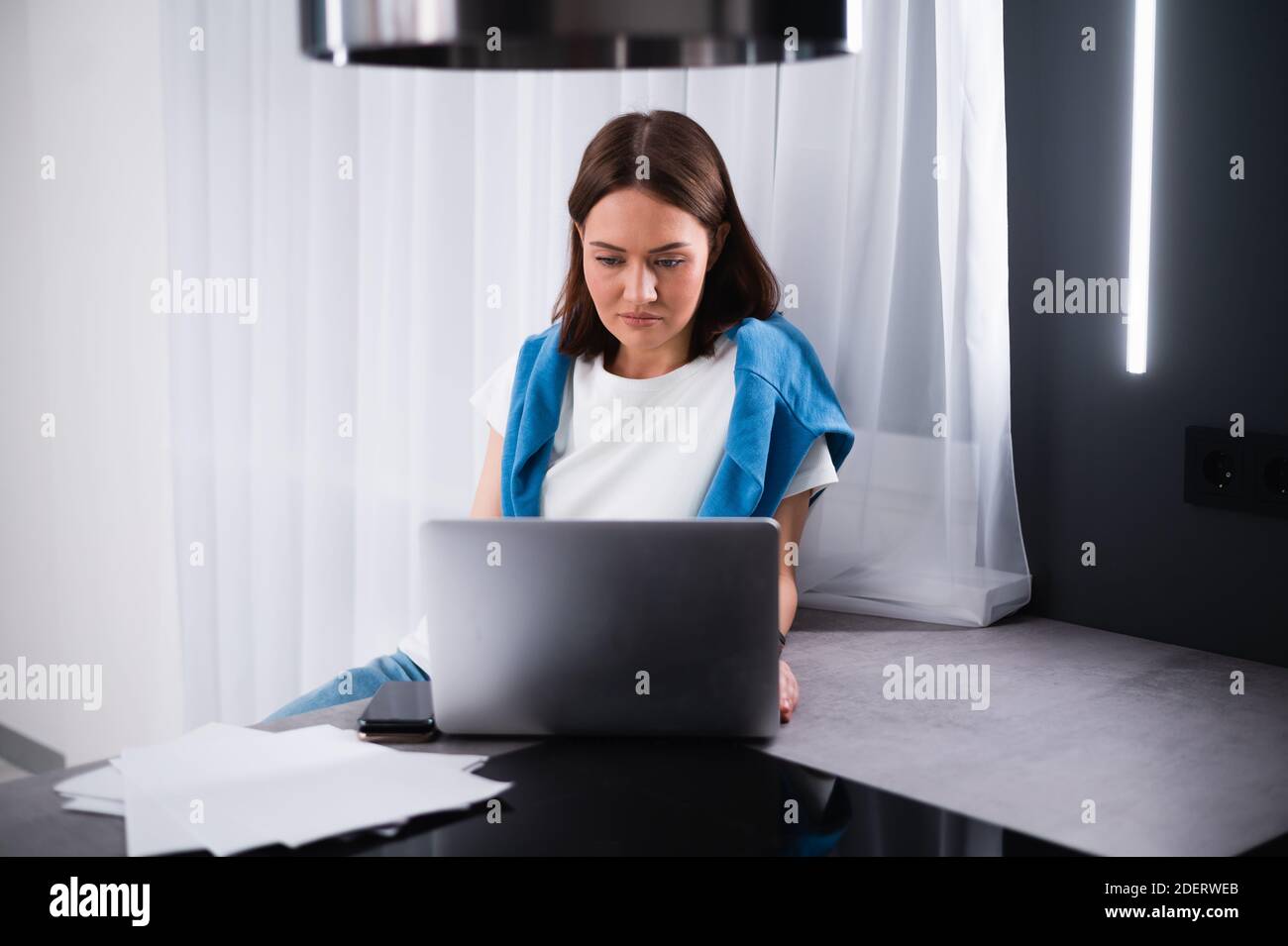 Woman working focused on laptop hi-res stock photography and images - Alamy