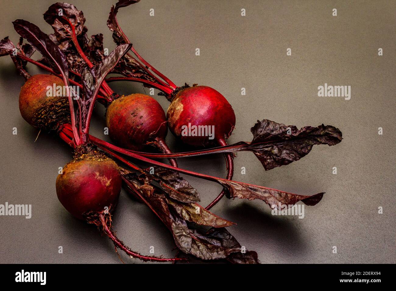 Fresh homegrown beetroot with leaves on black stone concrete background ...