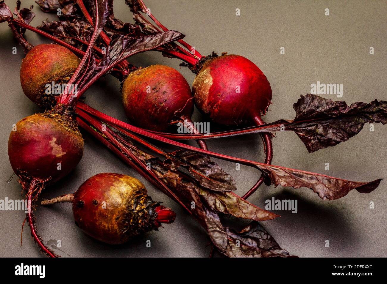 Fresh homegrown beetroot with leaves on black stone concrete background ...
