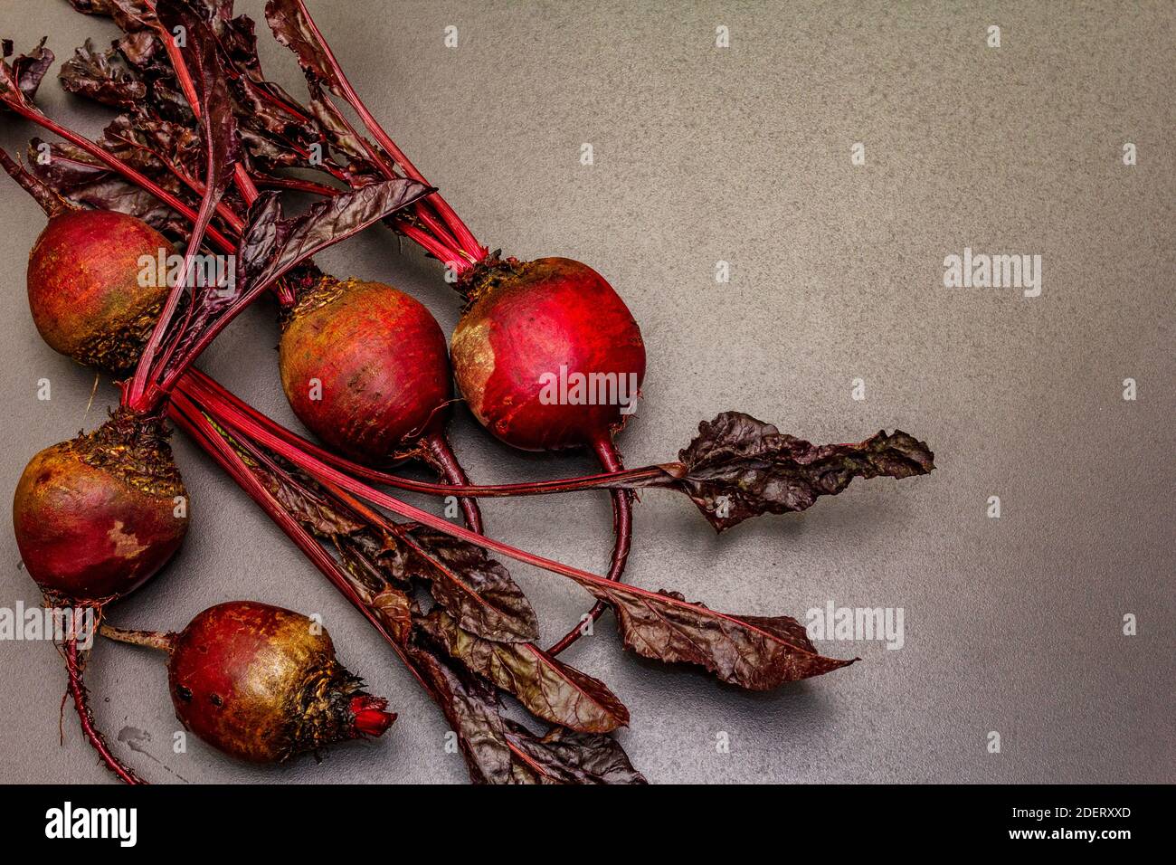 Fresh homegrown beetroot with leaves on black stone concrete background ...