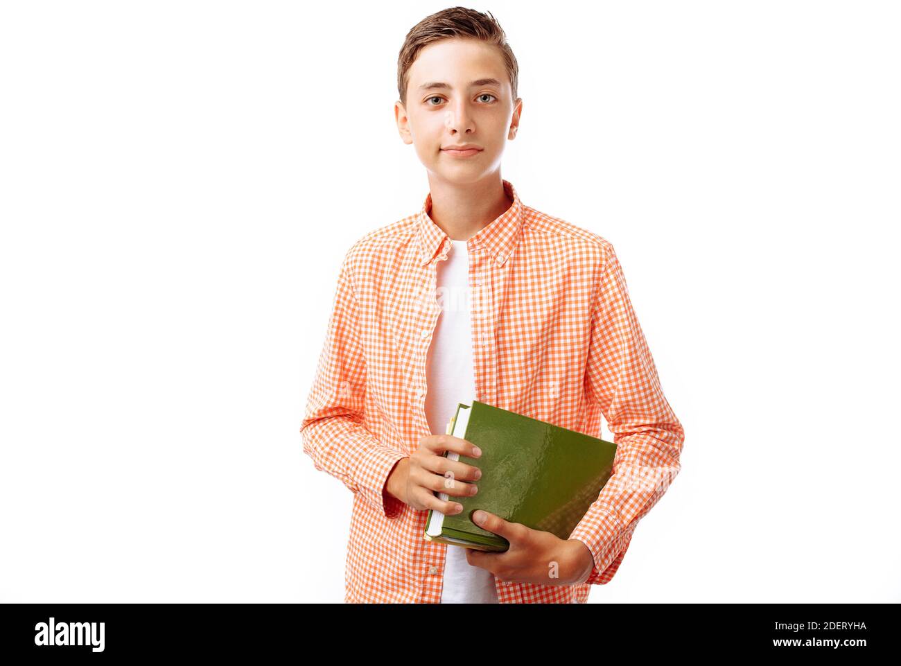 Portrait of a teenage boy, with a book in hand, student or schoolboy in ...