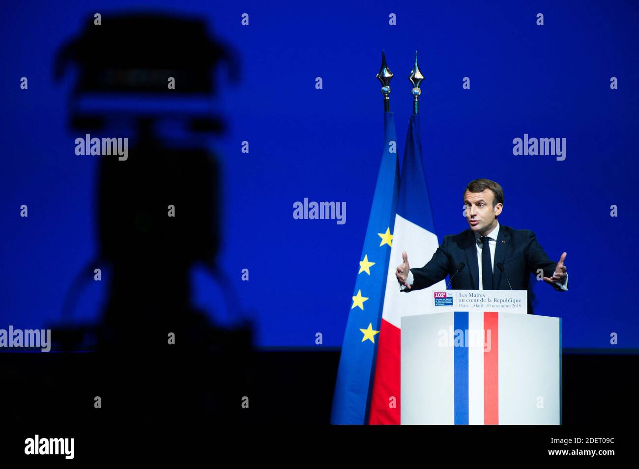 French President Emmanuel Macron and a video camera delivers a speech ...