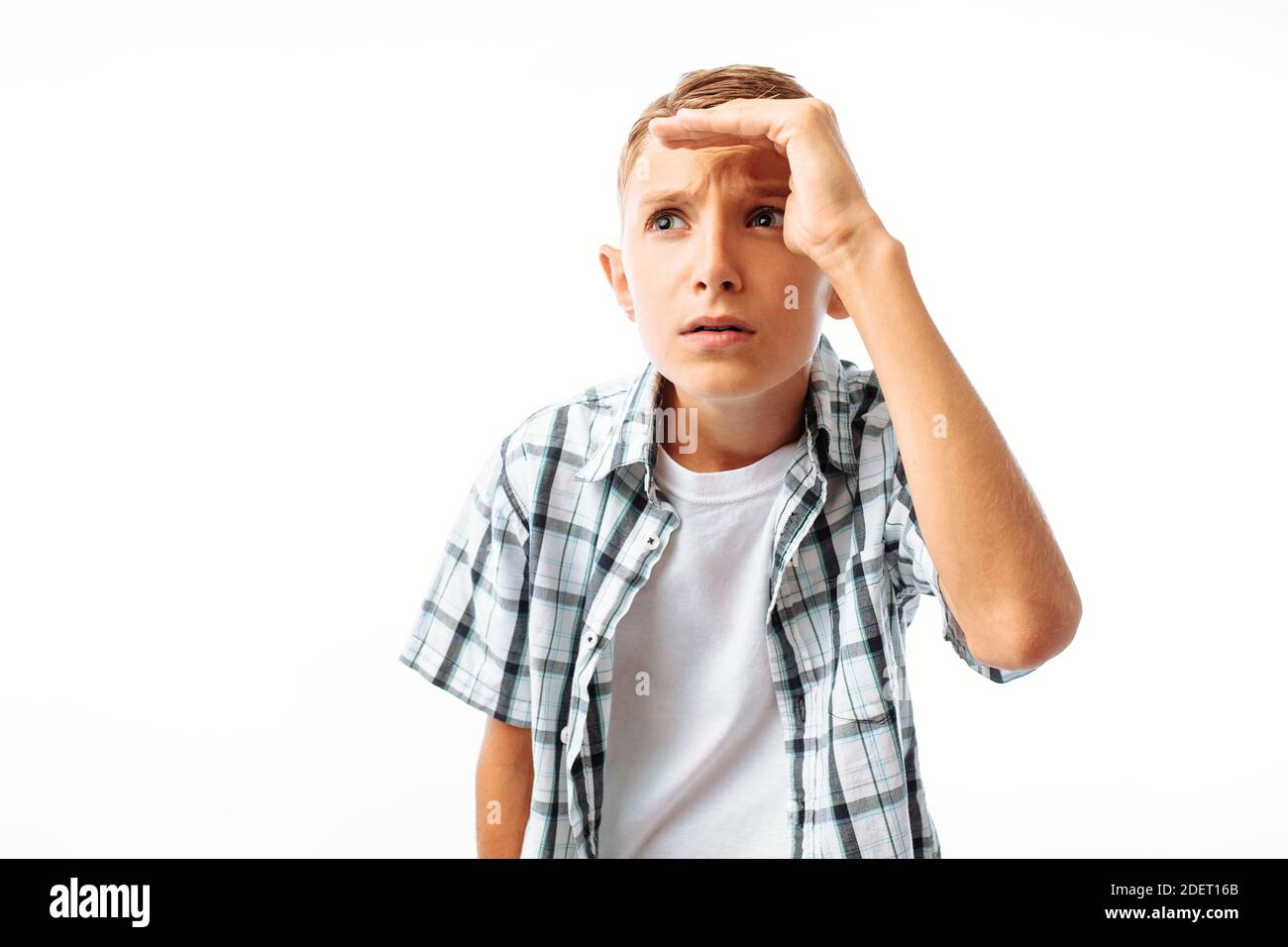 Handsome guy looking into the distance, holding his hand near his eyes ...