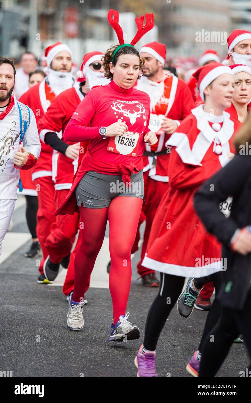 Participants wearing Santa Claus costumes take part in the Paris Santa ...