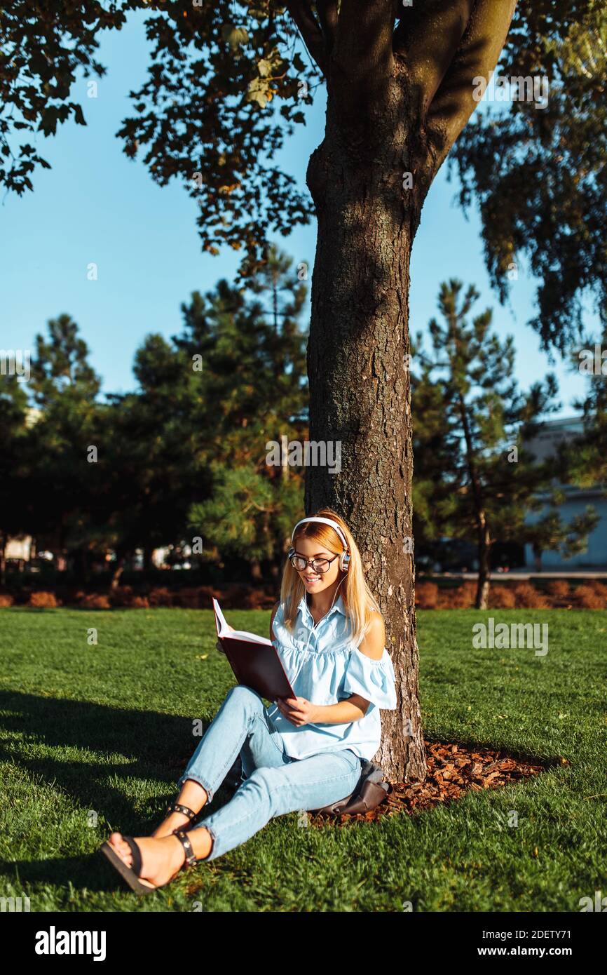 Beautiful blonde girl glasses sitting hi-res stock photography and ...