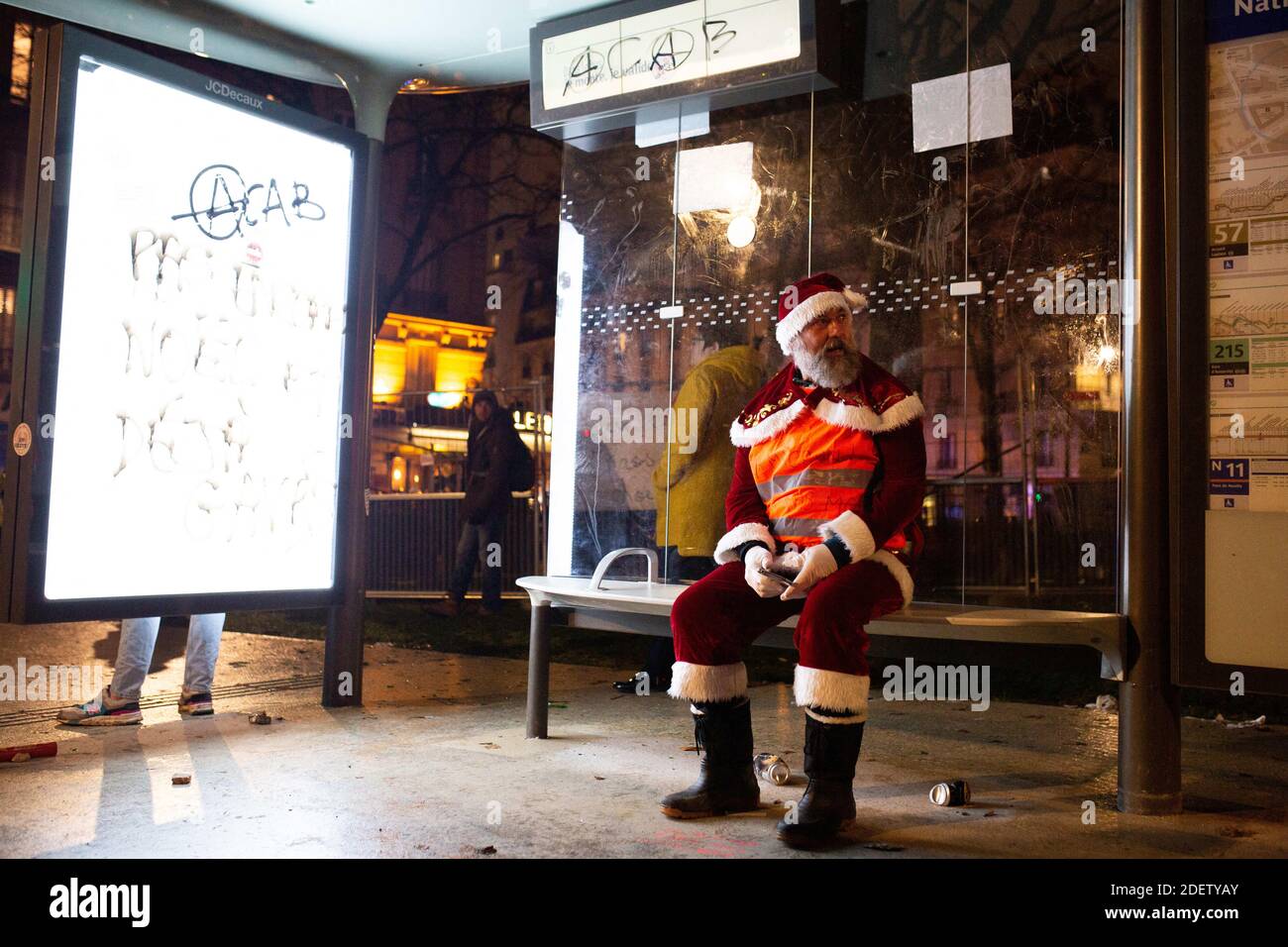 Protester dressed as santa claus on a bus stop with acab graffiti ...