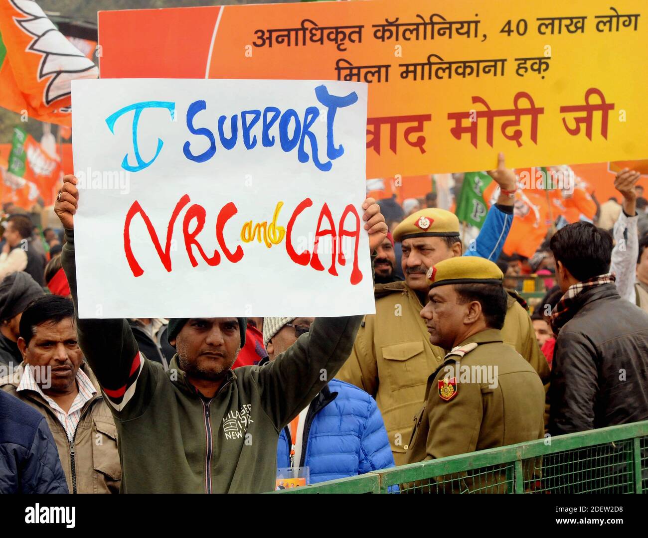 A supporter of the Bharatiya Janata Party (BJP) awaits the arrival of ...