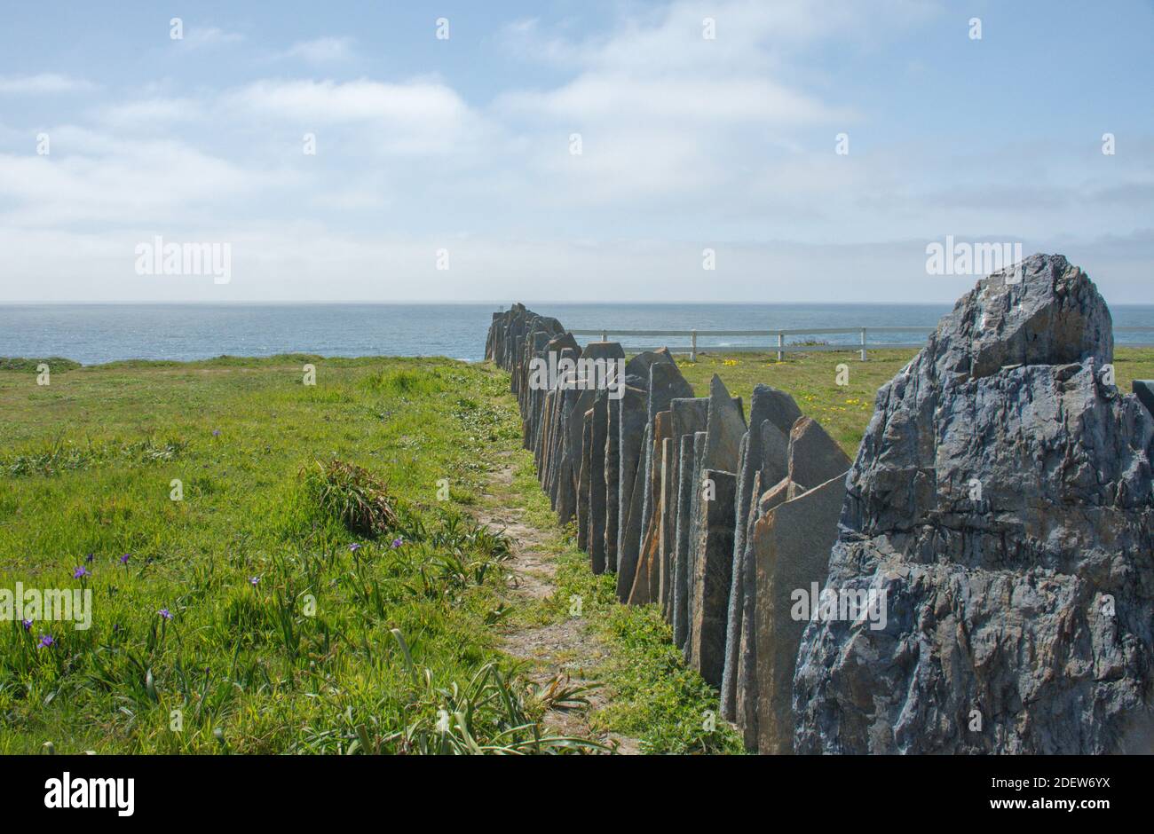 Rock Wall Pathway Leading To The Ocean Stock Photo - Alamy