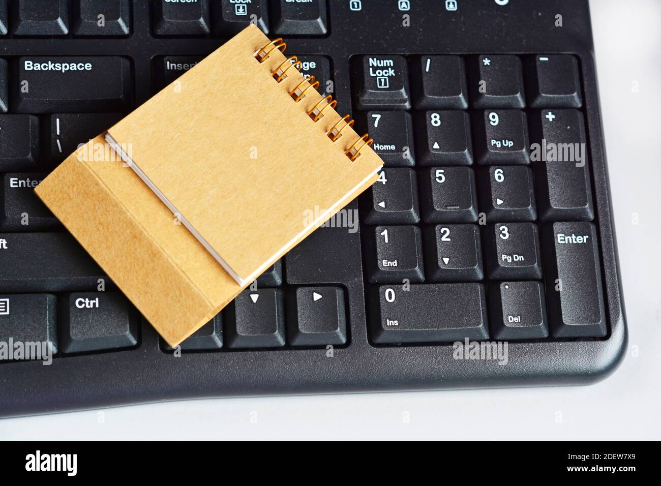 Blank notebook on top of black keyboard on the table. Working concept ...