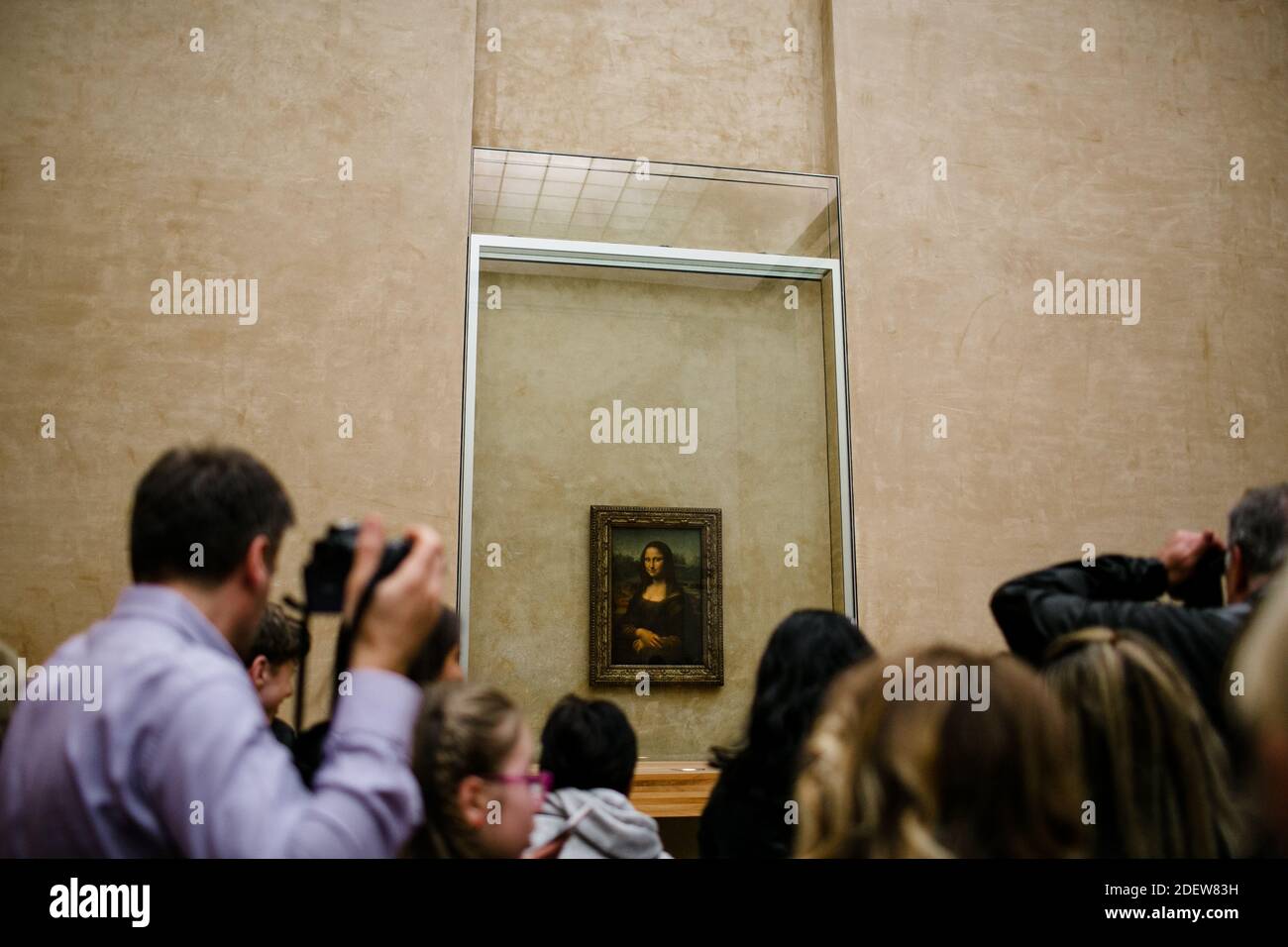 View of Mona Lisa Inside Louvre Through Crowd of People in Paris Stock ...