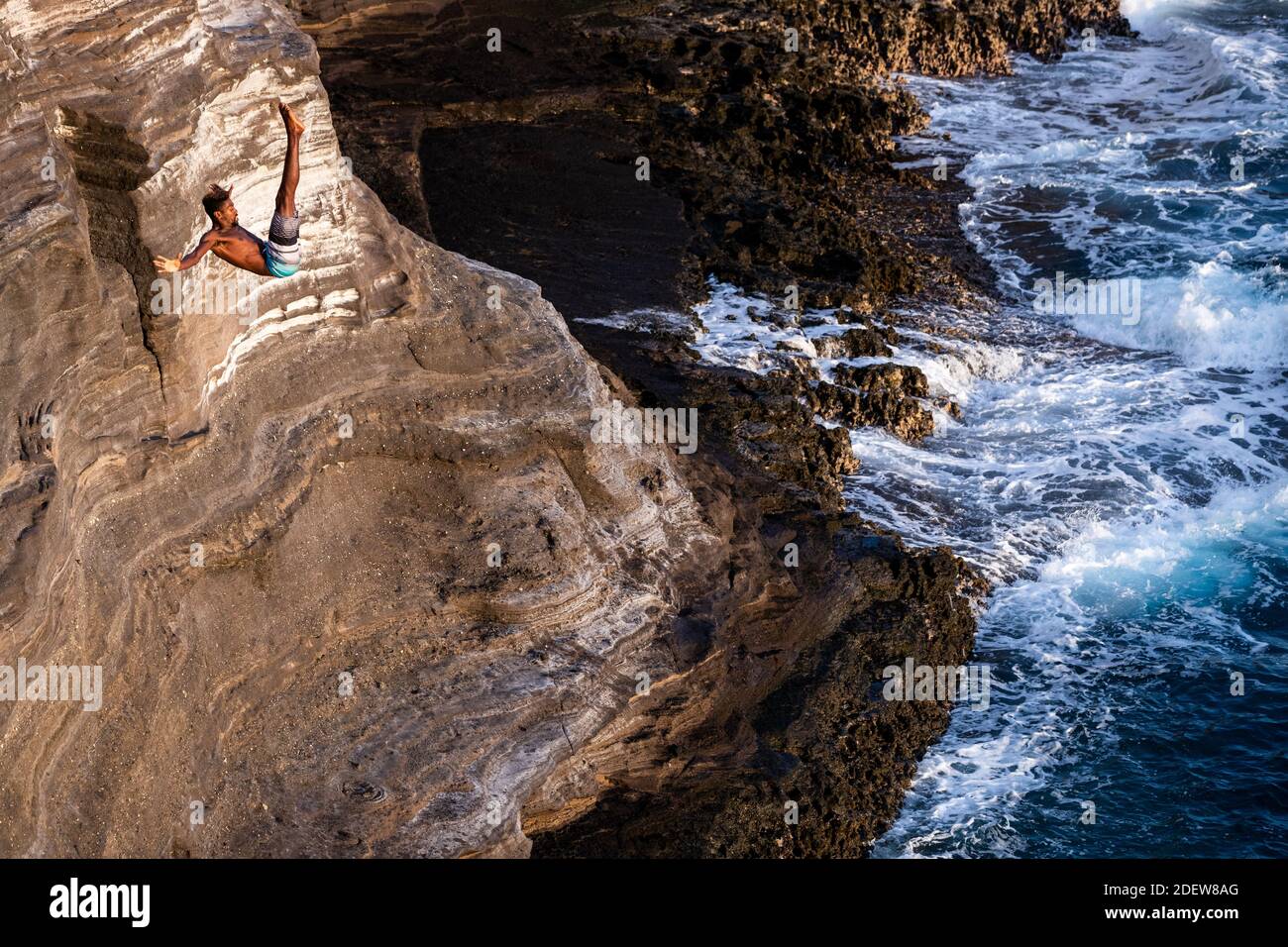 Cliff diver in a flip into the ocean in hawaii Stock Photo - Alamy
