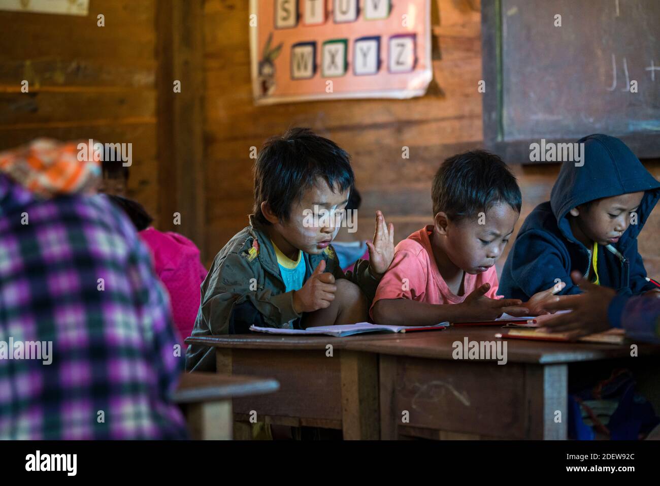 Young boys sitting at desks and learning Maths and how to count inside ...