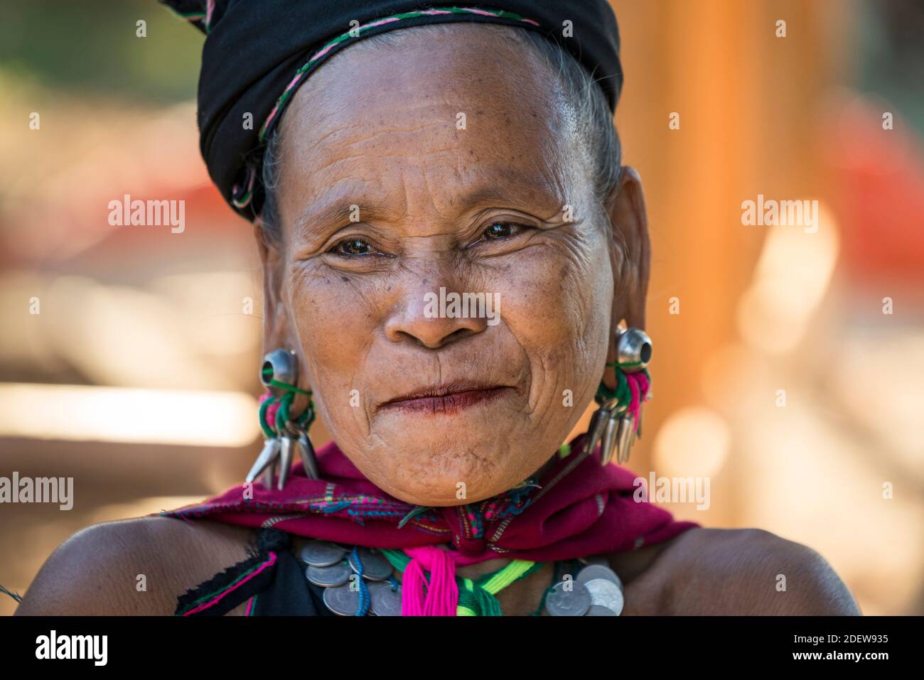 Portrait of smiling woman from Kayah tribe looking away, Loikaw ...
