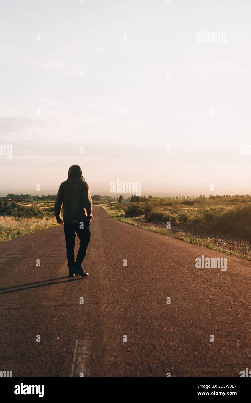 young man walking on street at sunrise Stock Photo - Alamy