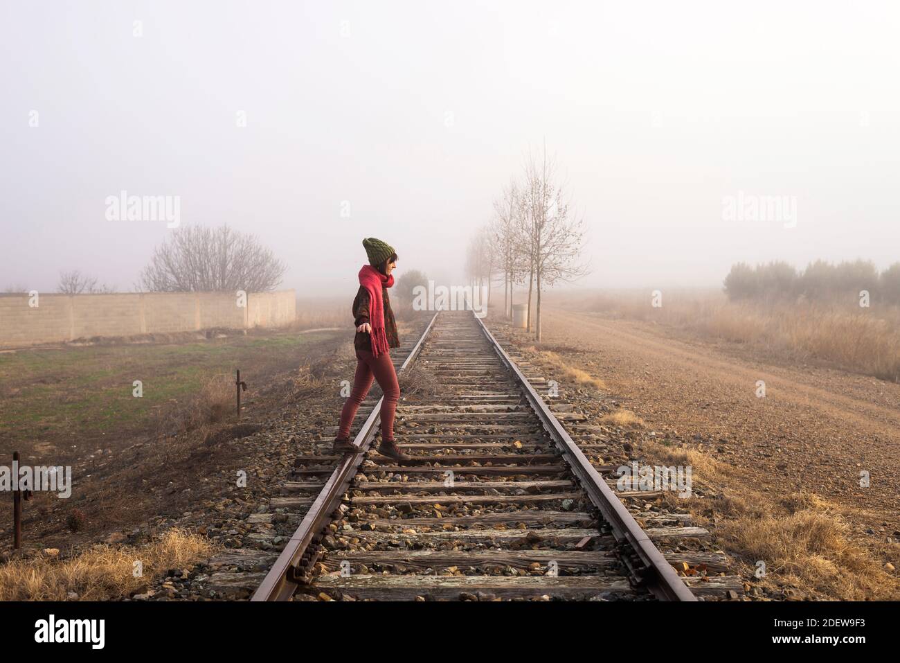 Side view of a girl balancing on train rail while walking Stock Photo ...