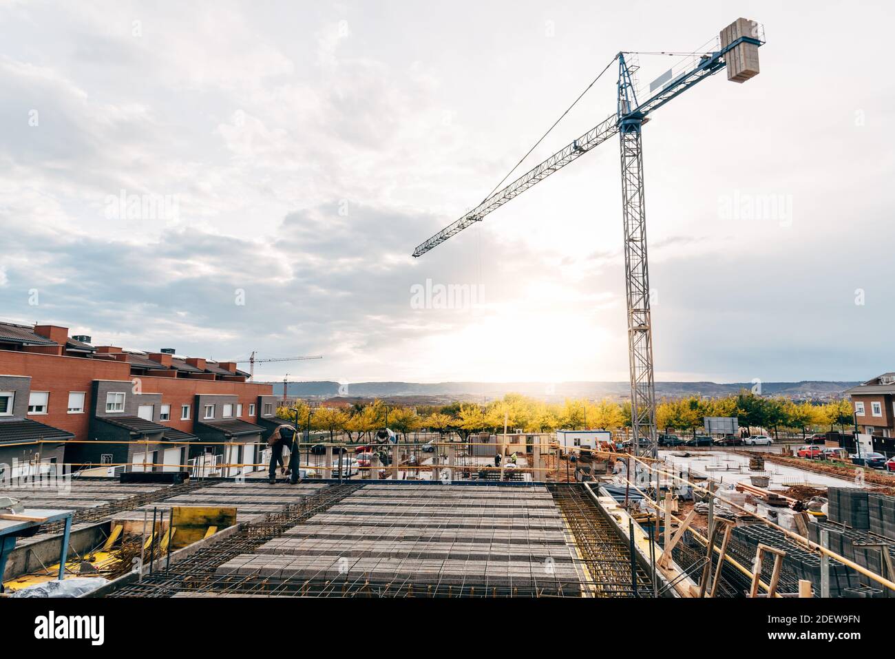 Construction worker working on a reinforced concrete slab at dawn Stock ...