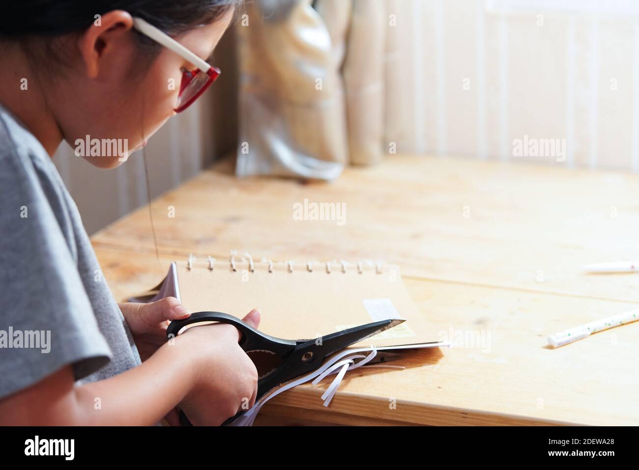 A girl trimming the hand craft book Stock Photo - Alamy