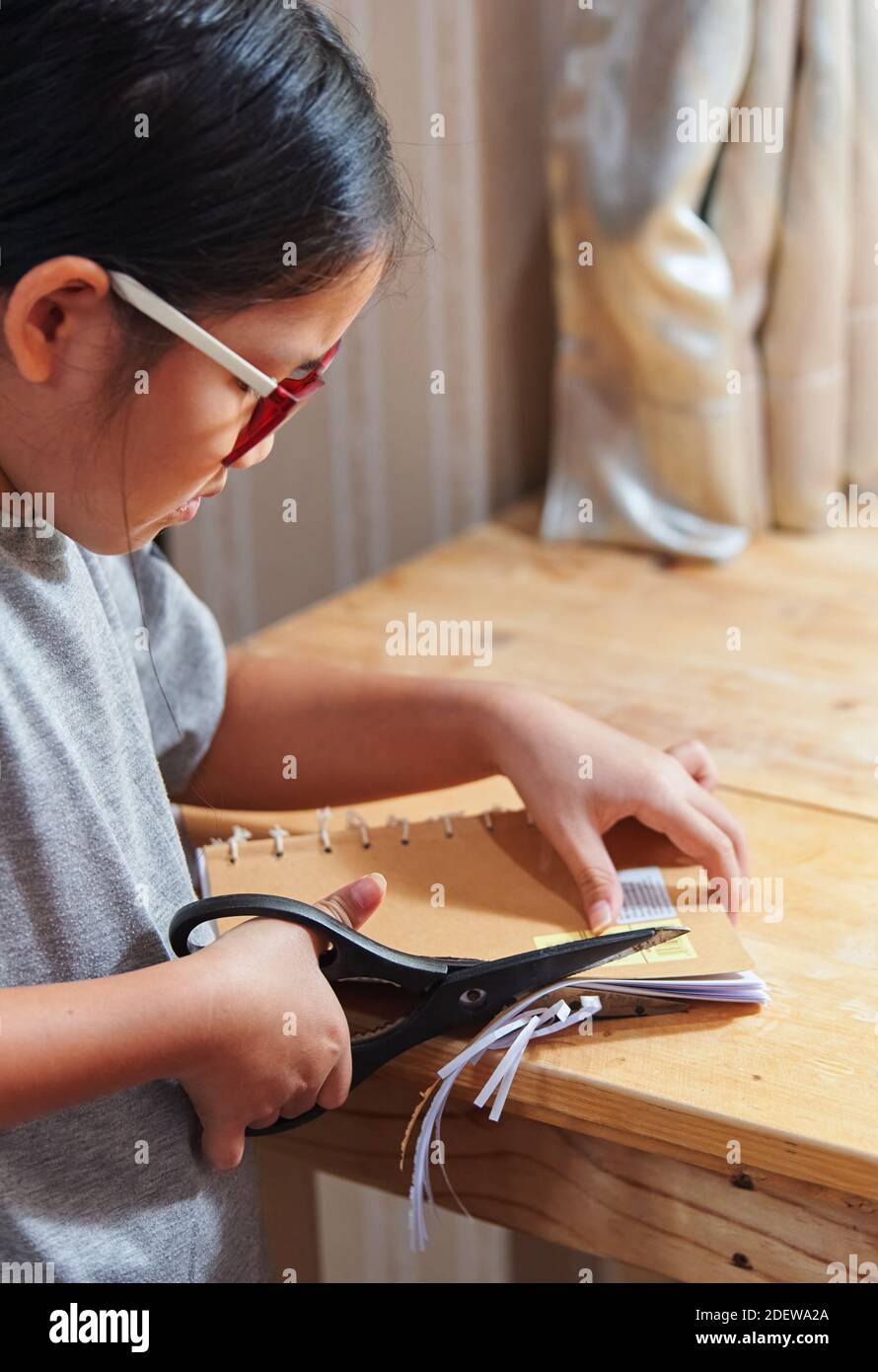 A girl trimming the hand craft book Stock Photo - Alamy