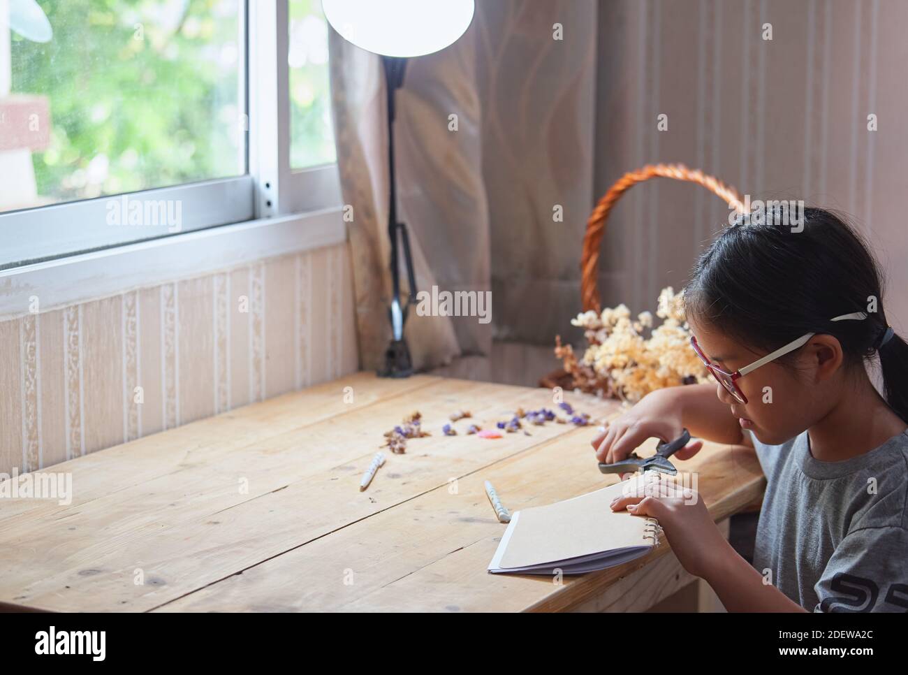 A girl trimming the hand craft book Stock Photo - Alamy