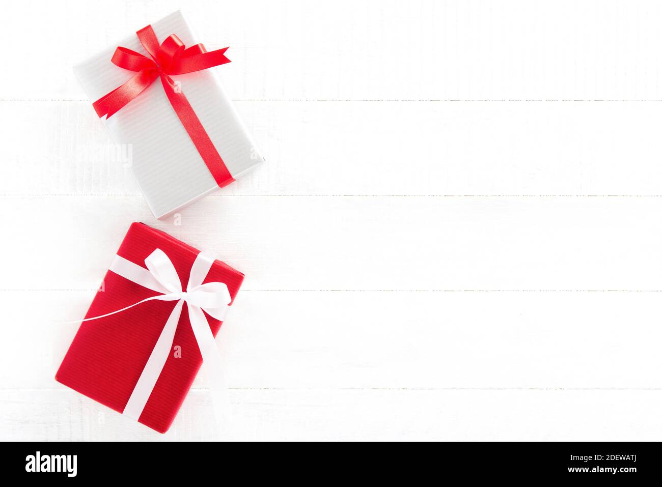 Gift boxes on white wood background, top view, border design with copy ...